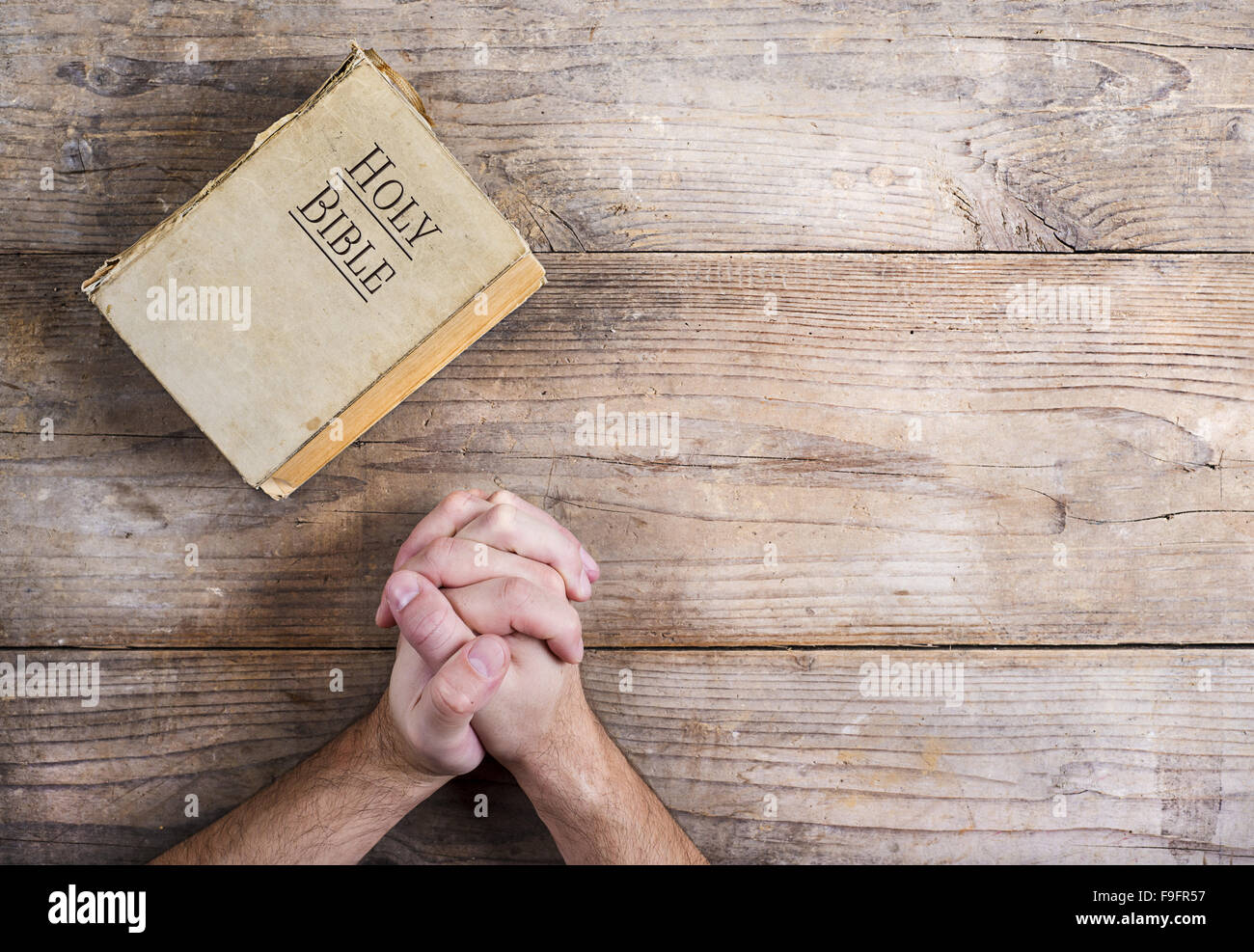 Praying Hands With Bible Background