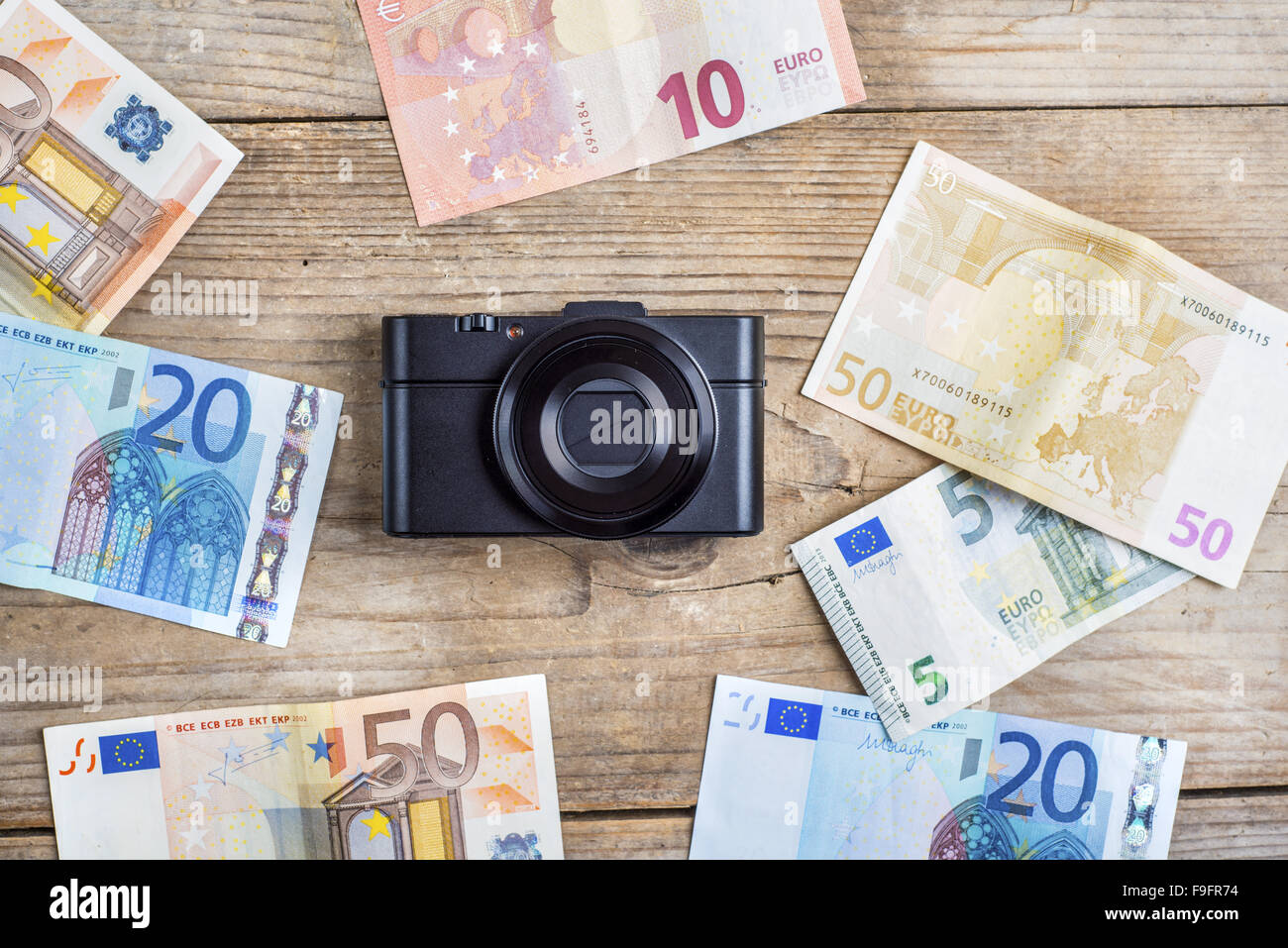 Old camera and bank notes on wooden desk background Stock Photo - Alamy
