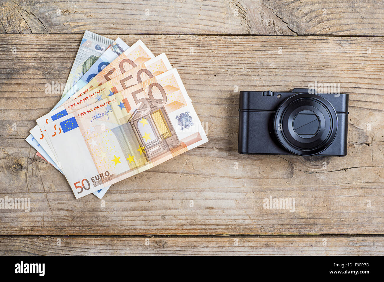 Old camera and bank notes on wooden desk background Stock Photo - Alamy