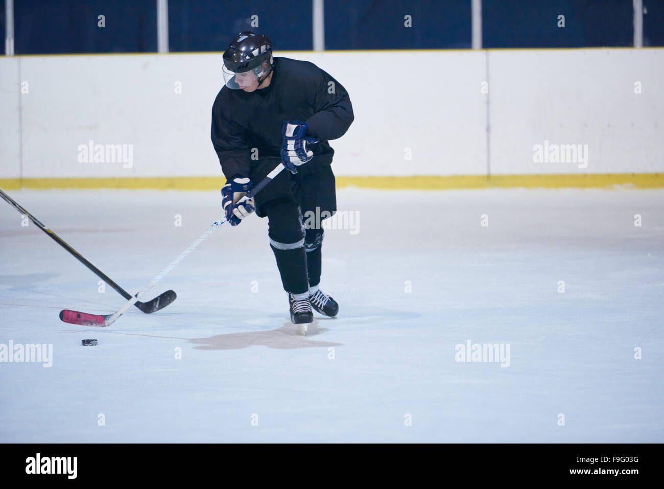 ice hockey player in action kicking with stick Stock Photo - Alamy