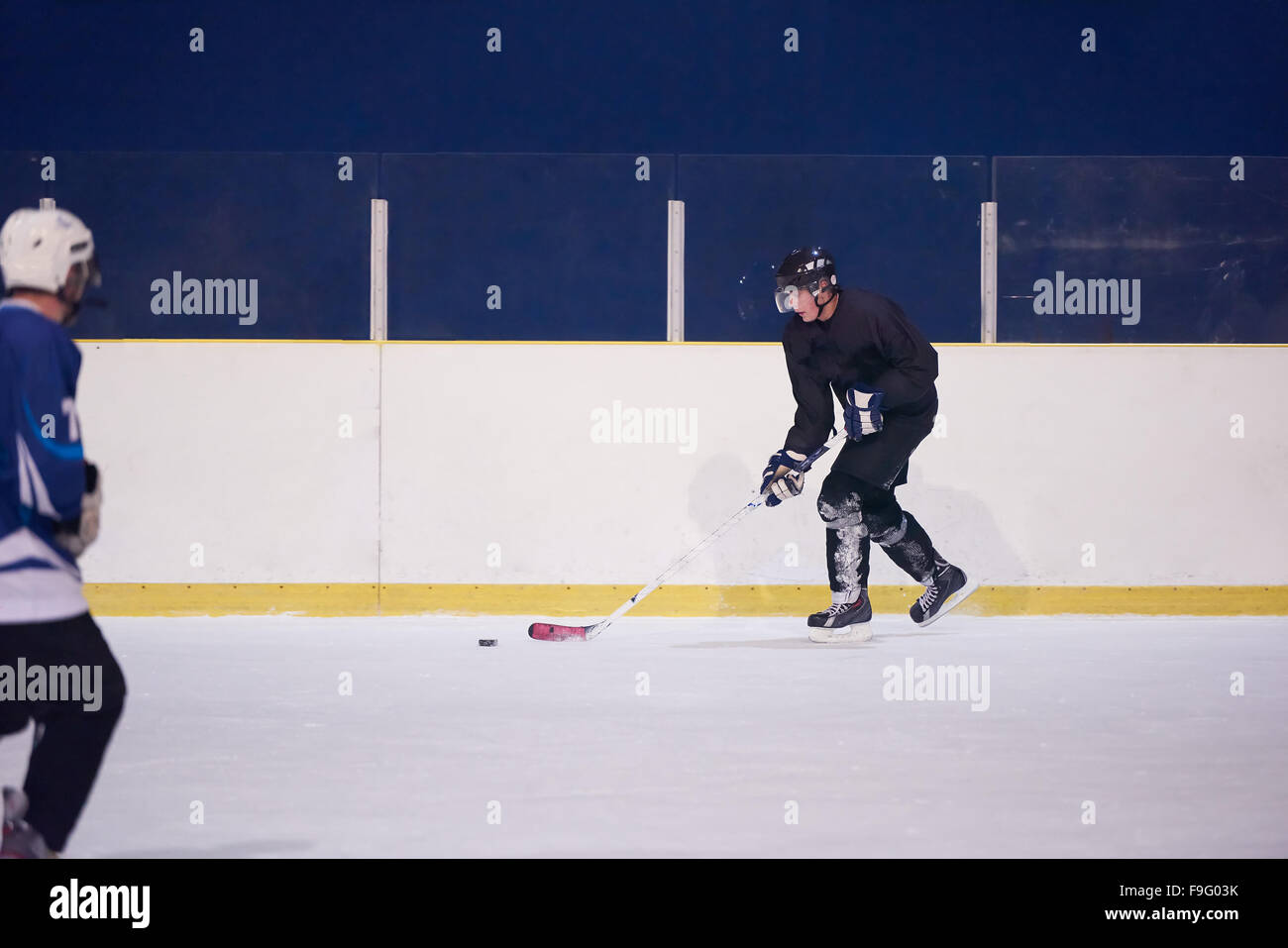 ice hockey player in action kicking with stick Stock Photo - Alamy