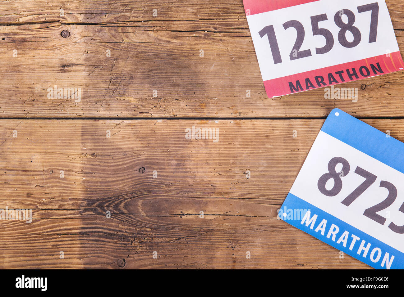 Two marathon race number laid on a wooden floor background Stock Photo ...