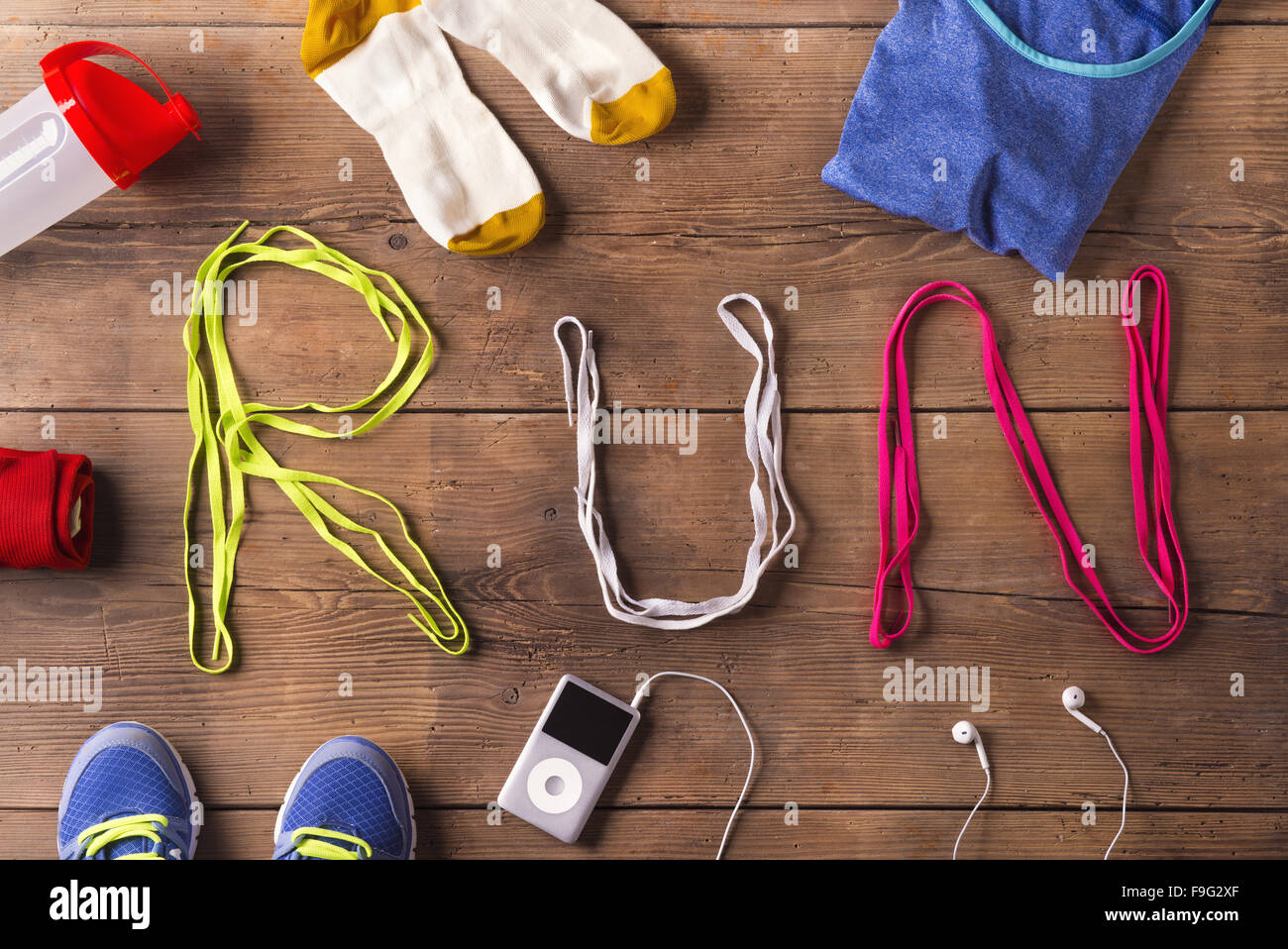 Shoelaces run sign and various running stuff on a wooden floor ...