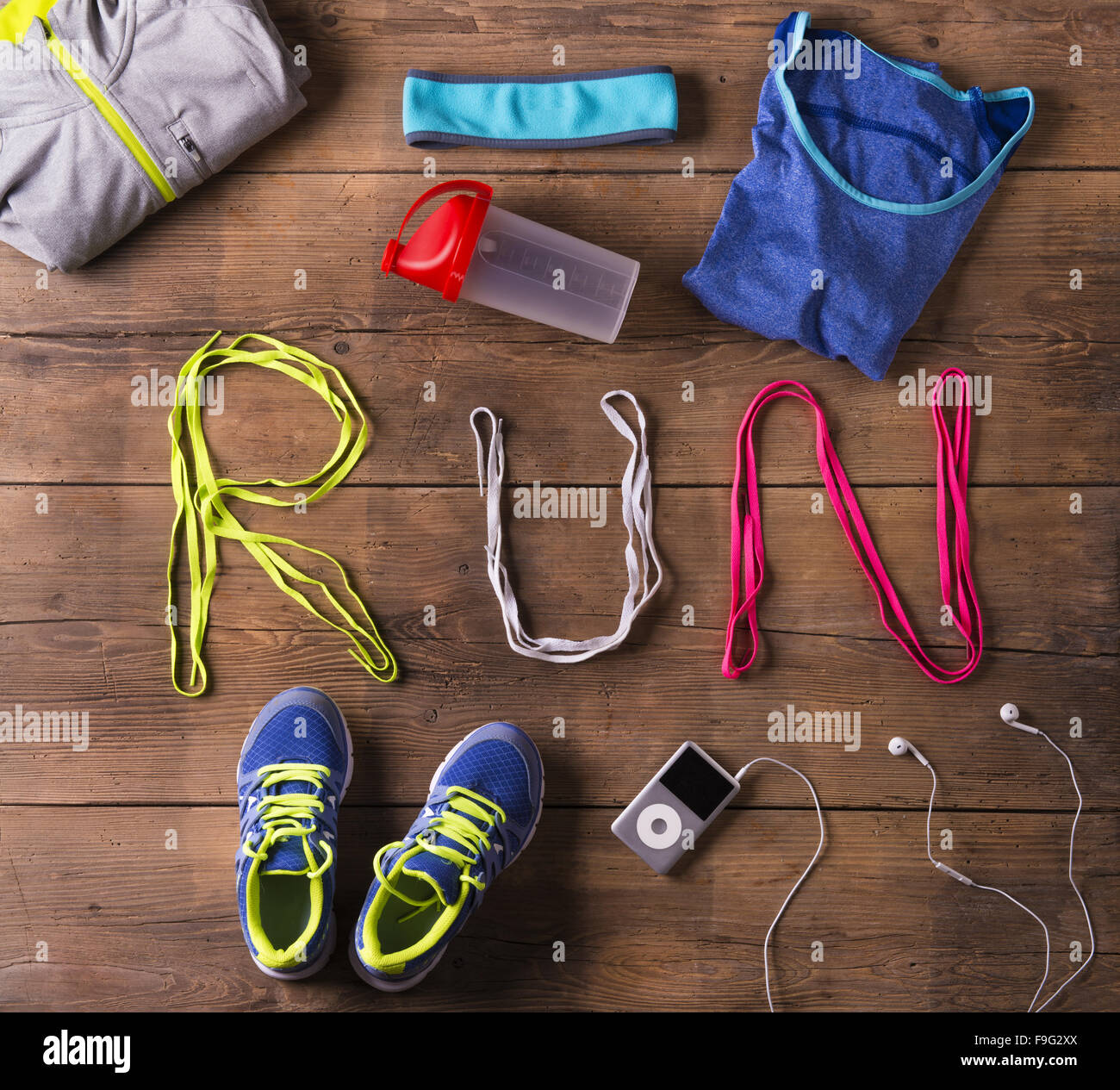 Shoelaces run sign and various running stuff on a wooden floor ...