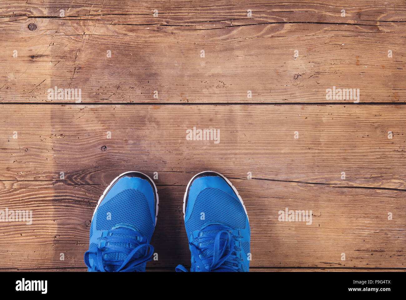 Feet of a runner on a wooden floor background Stock Photo - Alamy