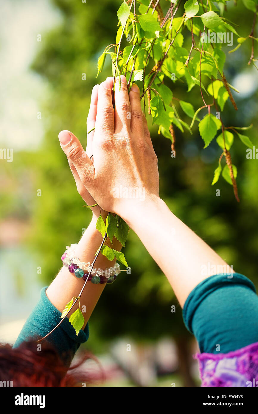 Spring prayer – adoring the healing powers of the spring, Tree in hands ...