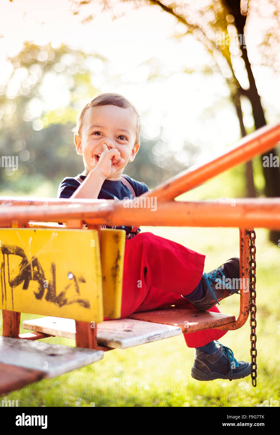 Cute little boy having fun on playground Stock Photo - Alamy