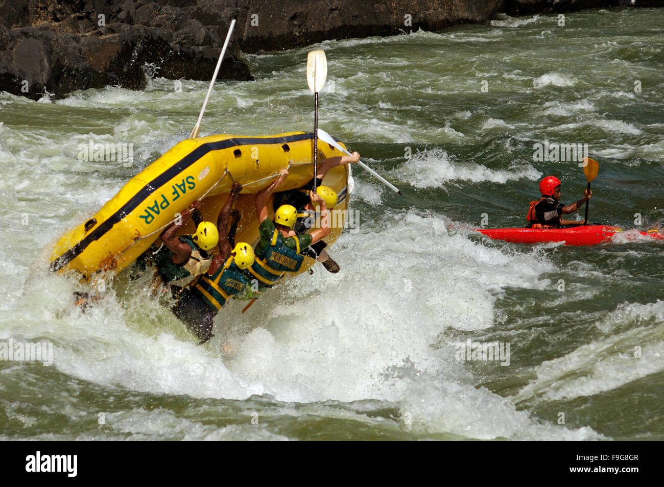 Yellow raft flipping on a wave at The Boiling Pot on the Zambezi River ...