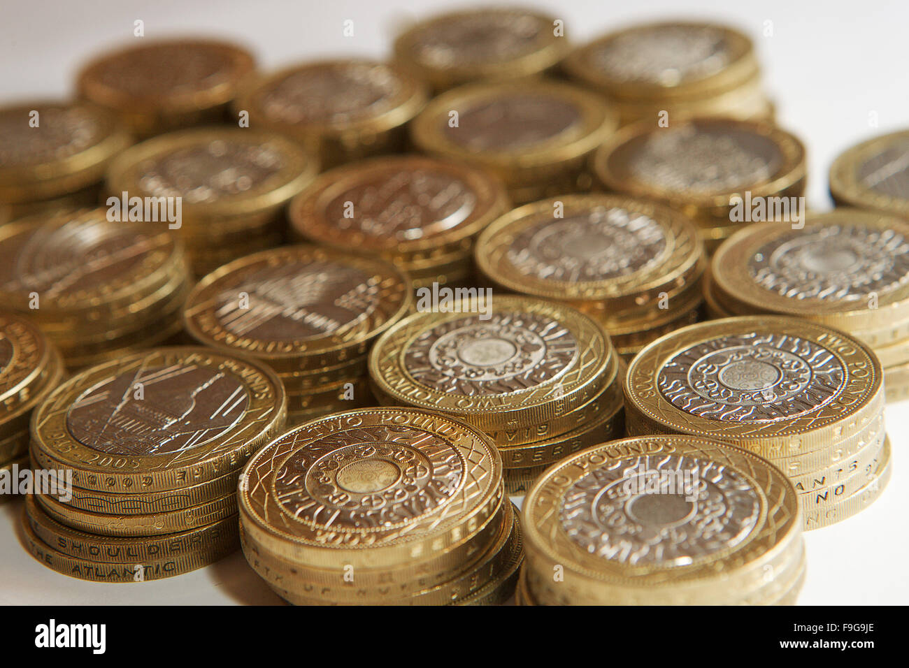 Angled shot of UK £2 coins stacking in piles of £10 Stock Photo - Alamy