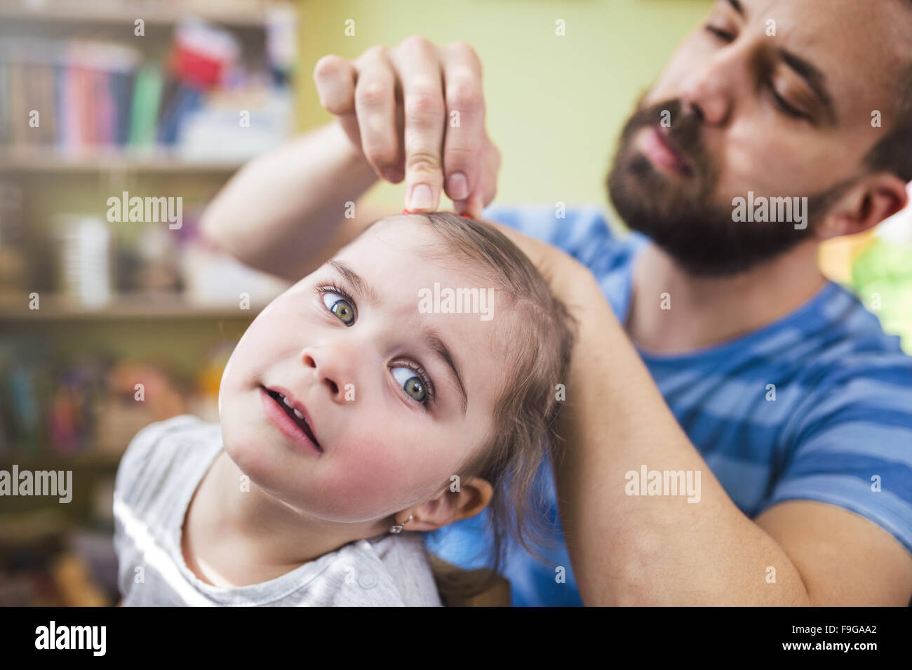 Young father styling hair of his daughter Stock Photo - Alamy