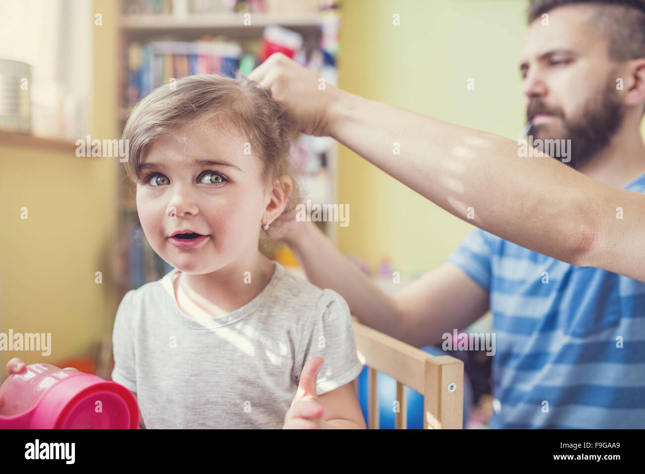 Young father styling hair of his daughter Stock Photo - Alamy
