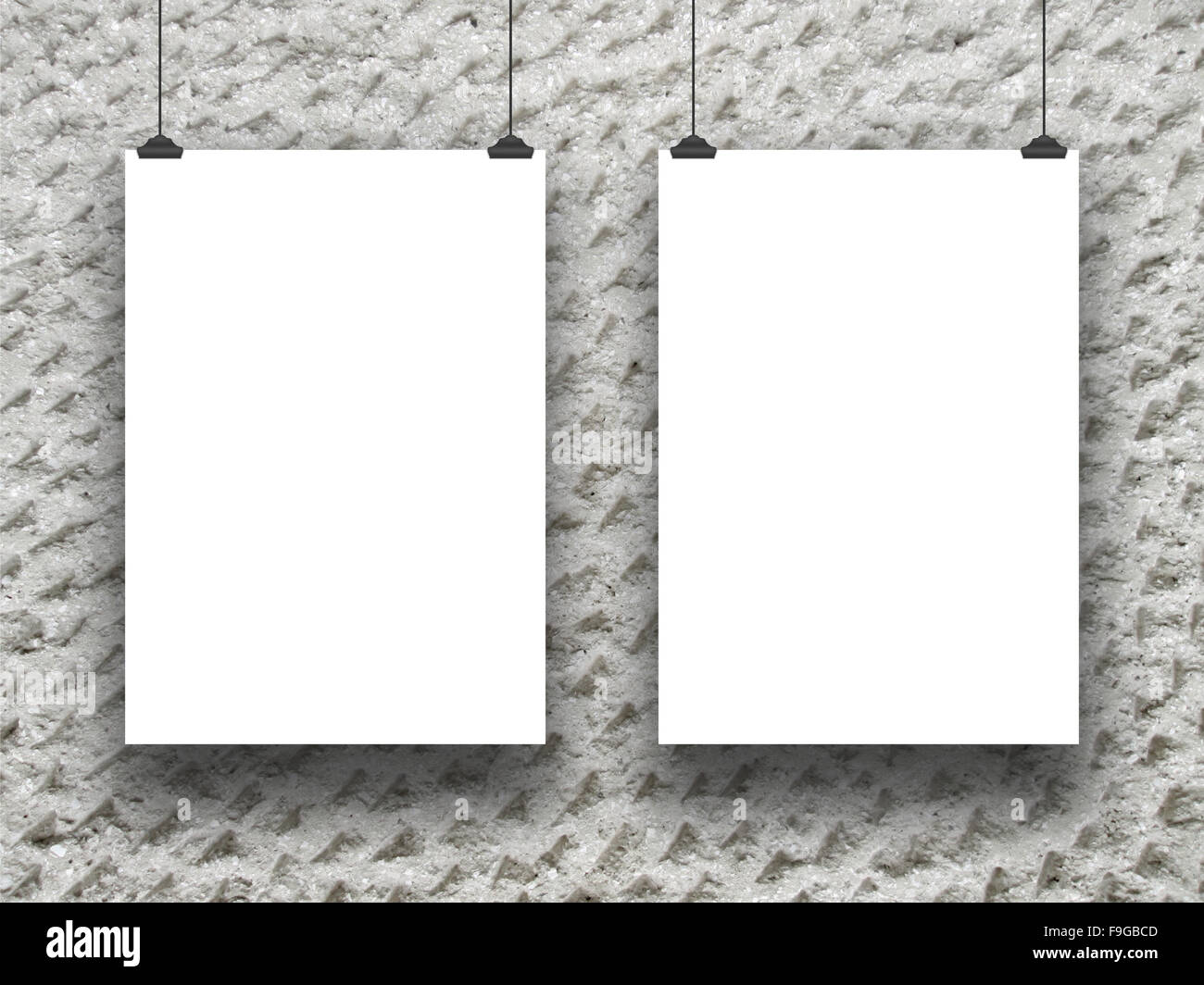 Close-up of two white paper sheet frames on gray concrete wall ...