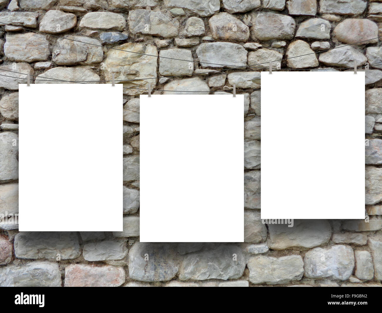 Close-up of three paper sheet frames hung by clothes pin on ancient ...