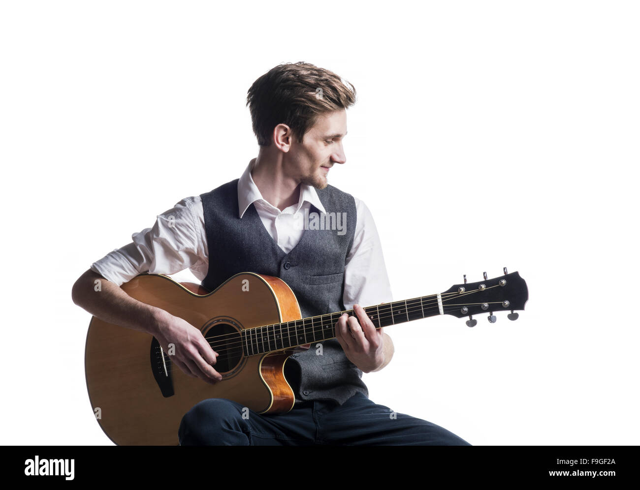 Young handsome guitar player. Studio shot on white background Stock ...