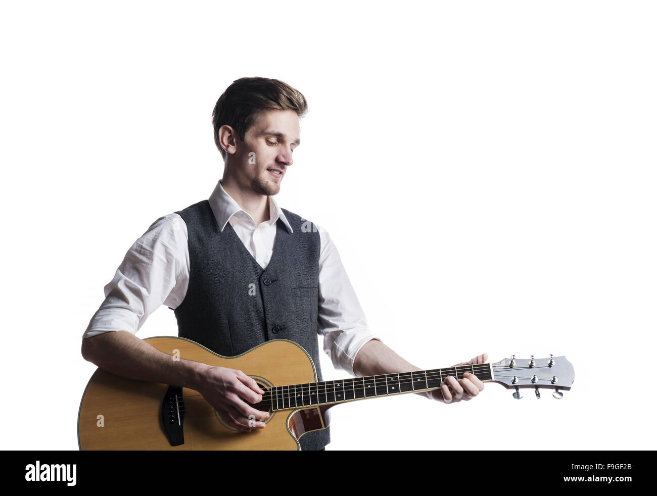 Young handsome guitar player. Studio shot on white background Stock ...
