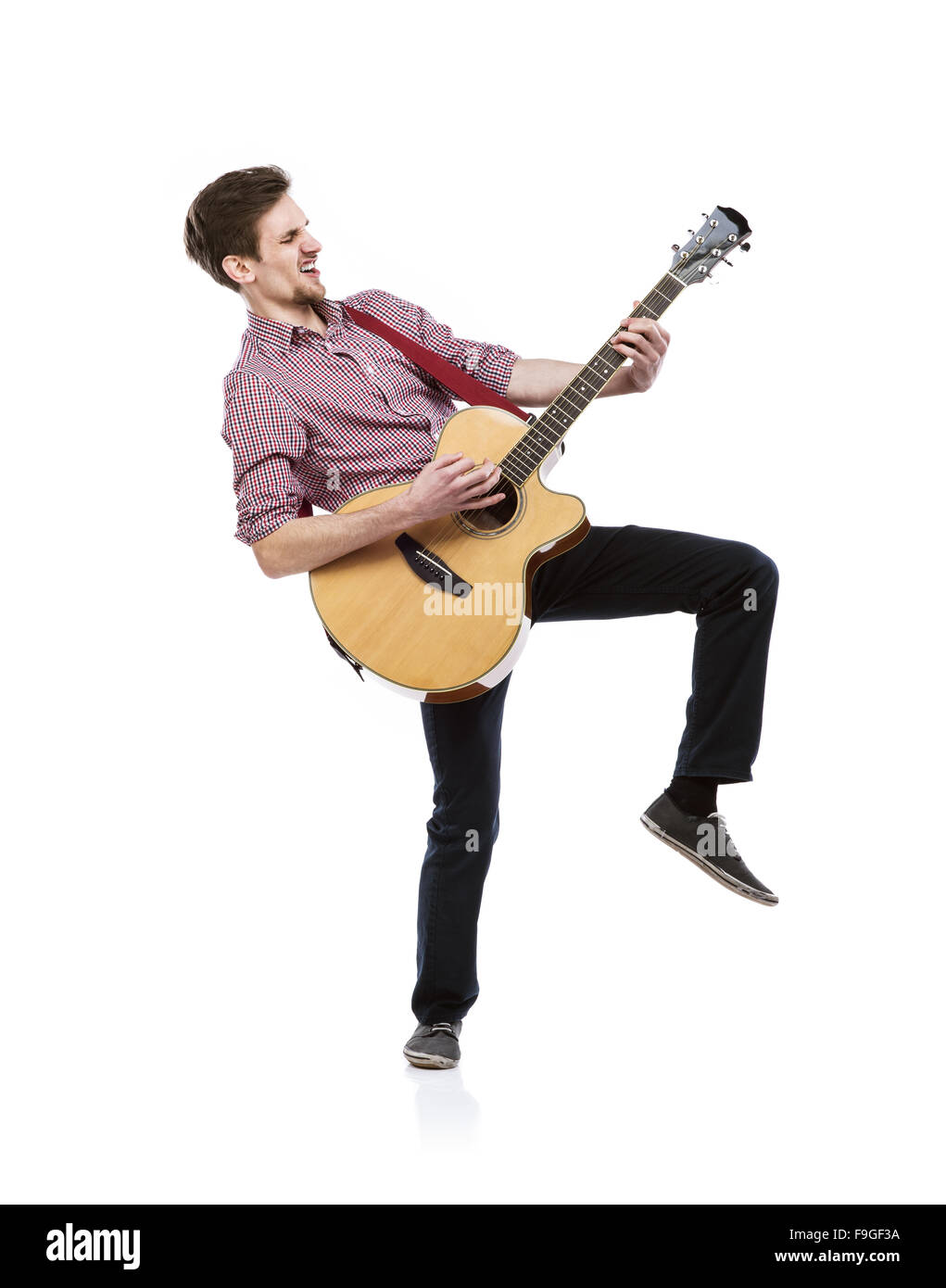 Young handsome guitar player with his instrument. Studio shot on white ...