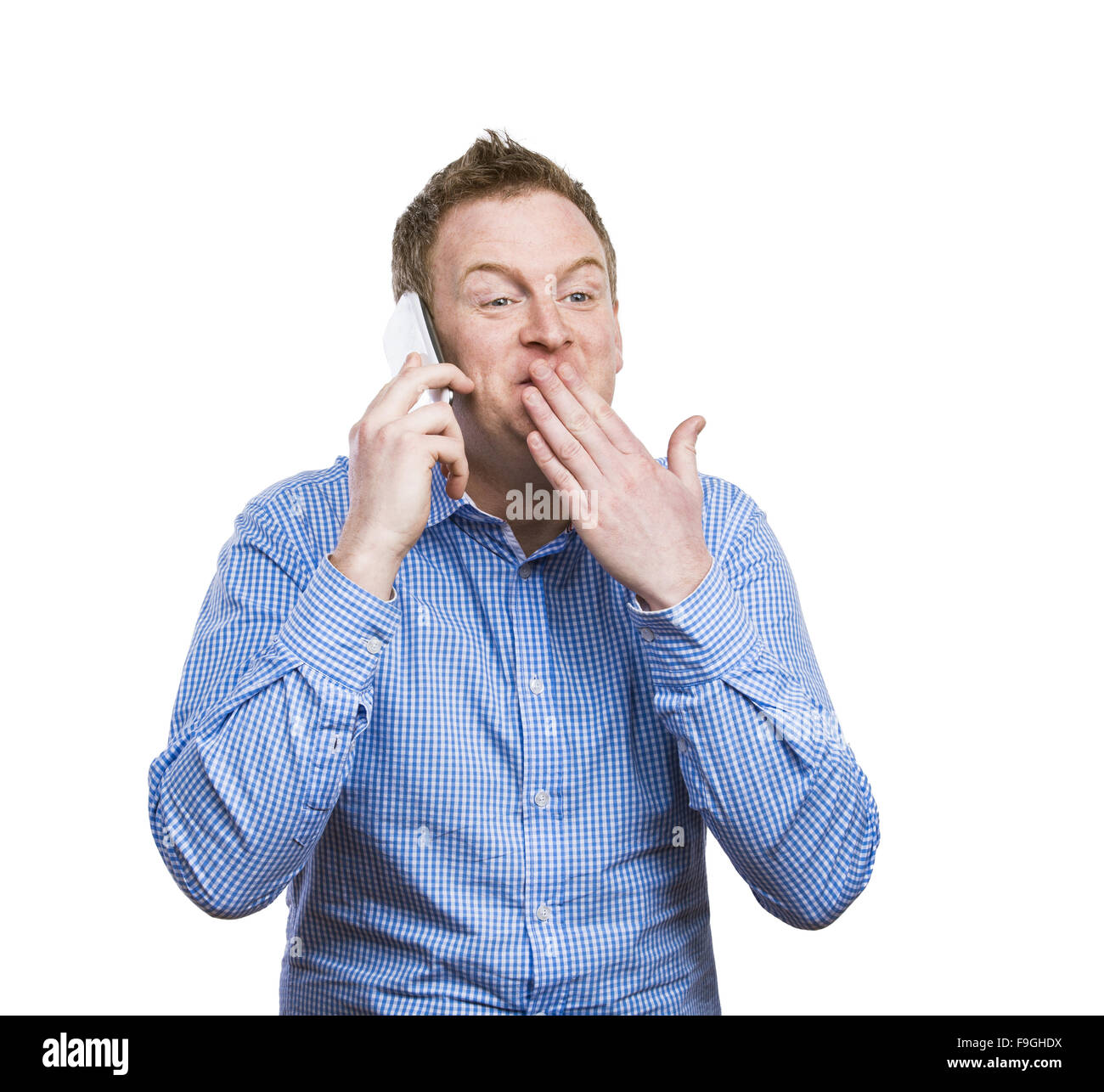 Man making funny faces while making a phone call. Studio shot on white ...