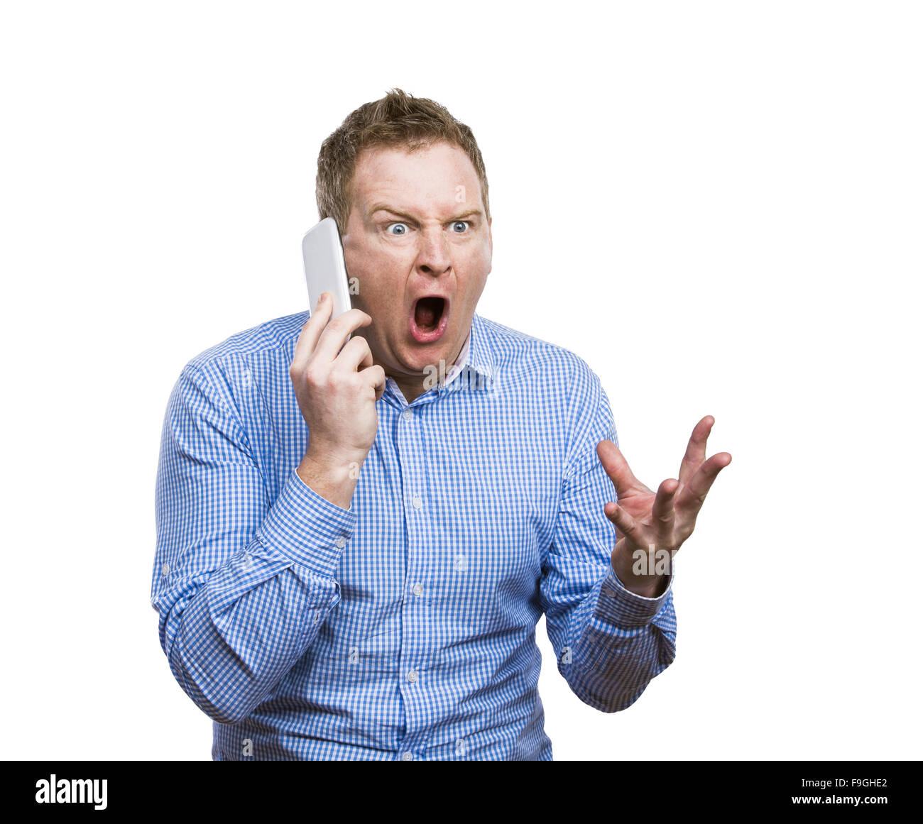 Man making funny faces while making a phone call. Studio shot on white ...