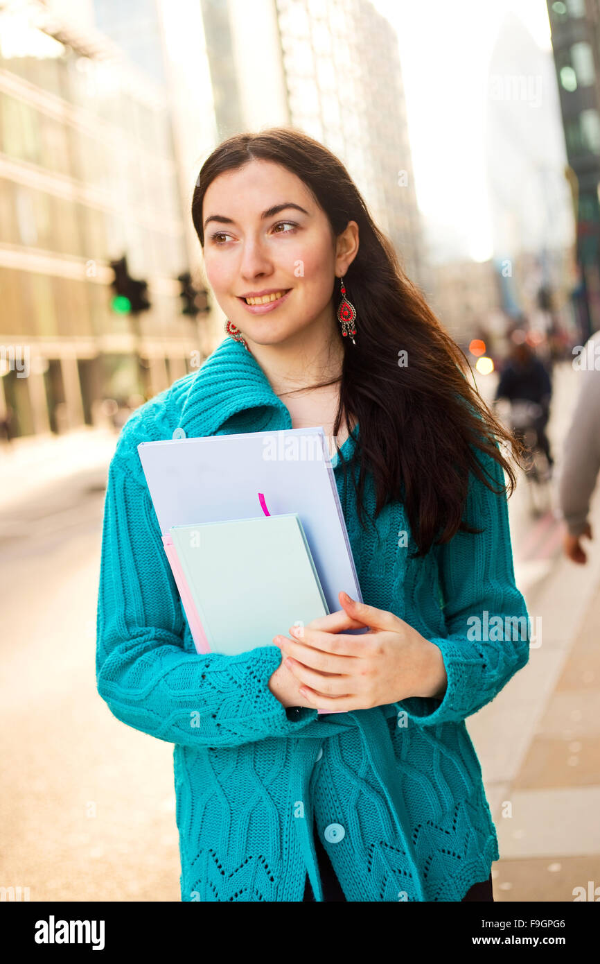 Woman holding books standing hi-res stock photography and images - Alamy