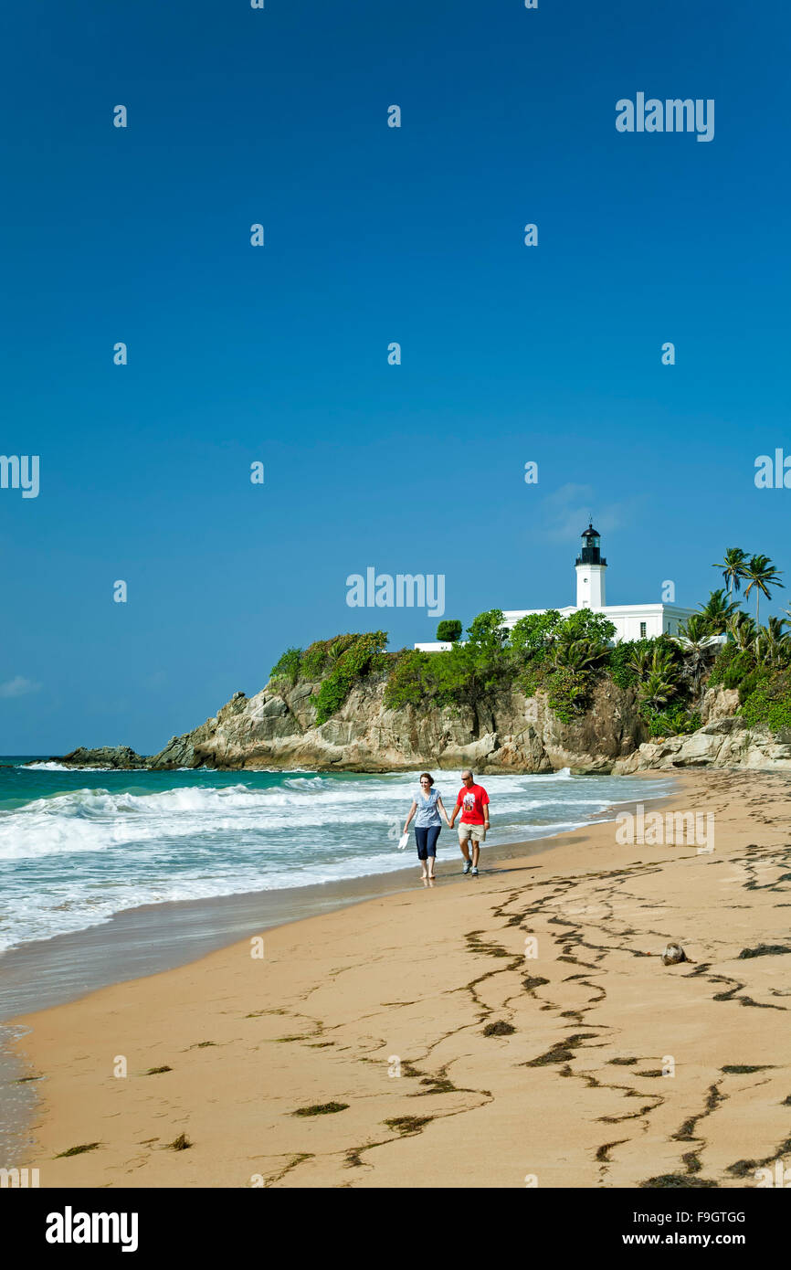 Couple walking on beach and Punta Tuna Lighthouse (1892), Maunabo ...