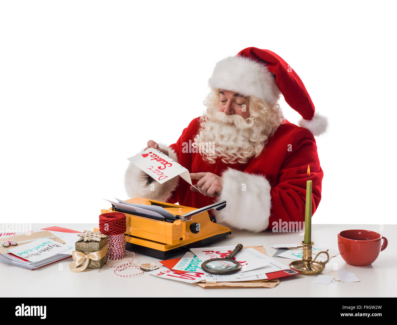Santa Claus reading children letters and writing responses to them ...