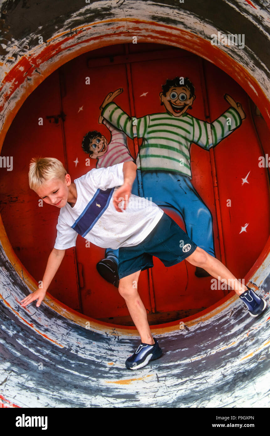 Young boy in fun house barrel Stock Photo - Alamy