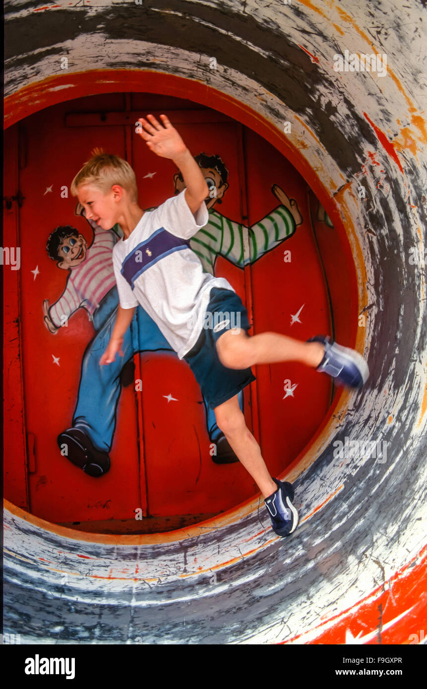Young boy in fun house barrel Stock Photo - Alamy