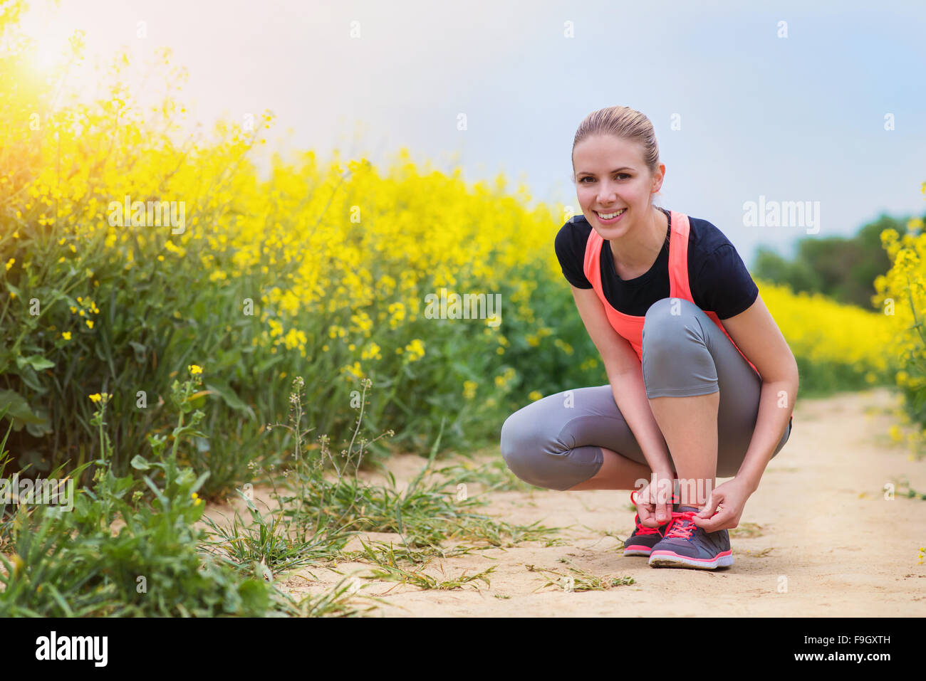 Beautiful young woman running outside in spring canola field Stock ...