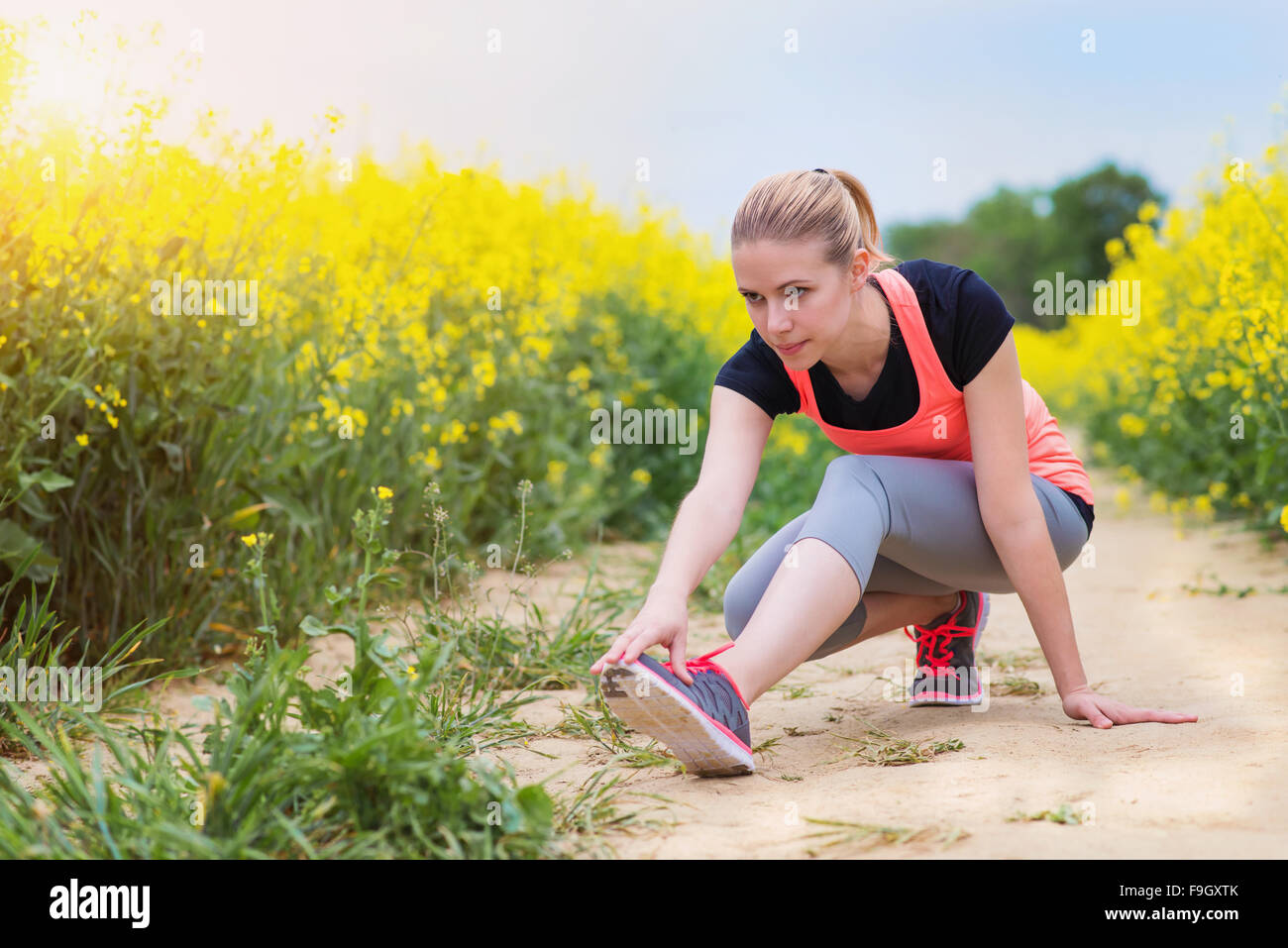 Beautiful young woman running outside in spring canola field Stock ...