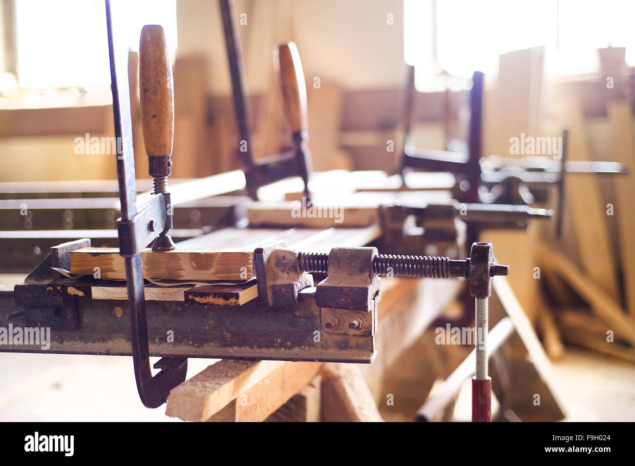 Carpenter screw clamp tools pressing planks together Stock Photo - Alamy