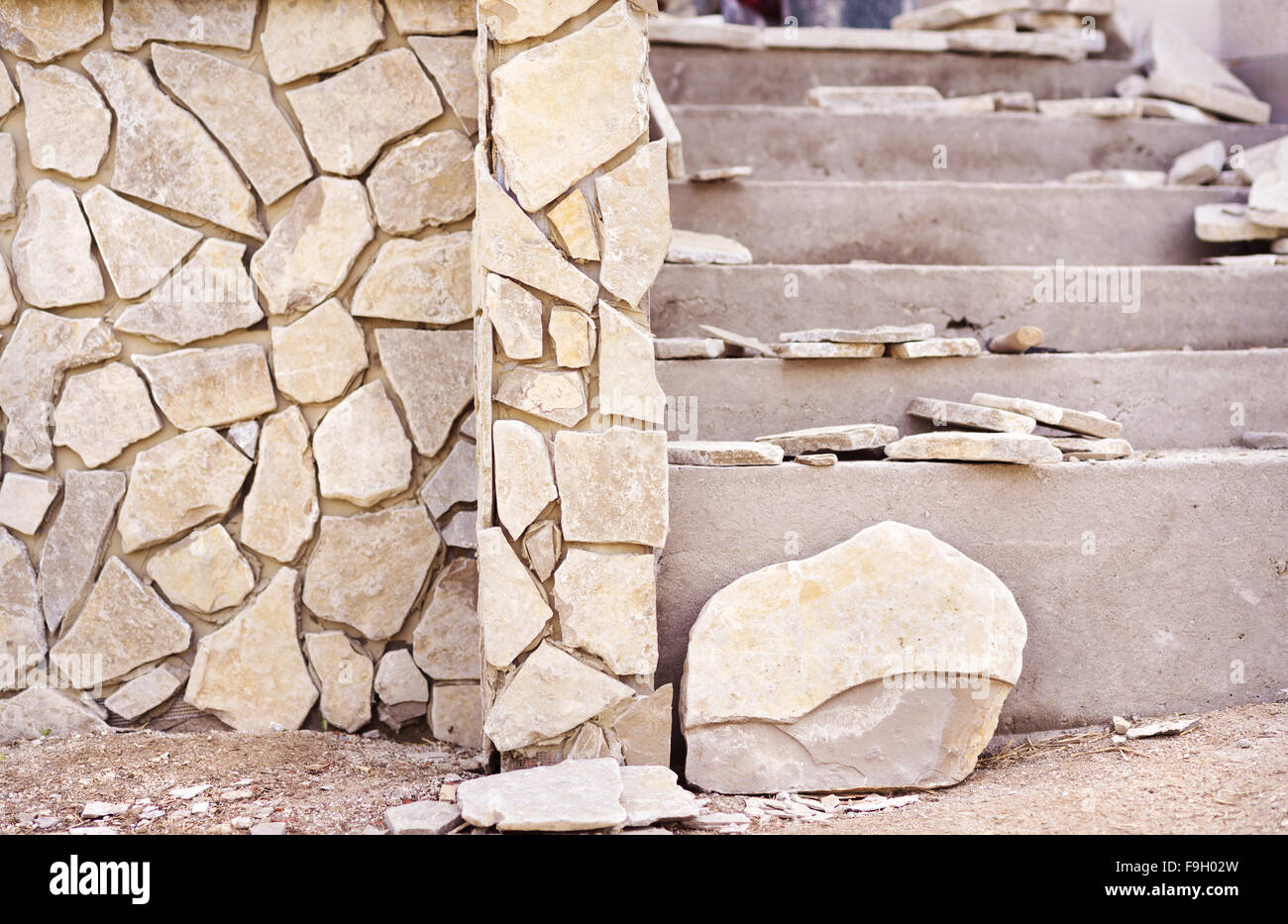 Close up of an unfinished stairs and stone wall Stock Photo - Alamy