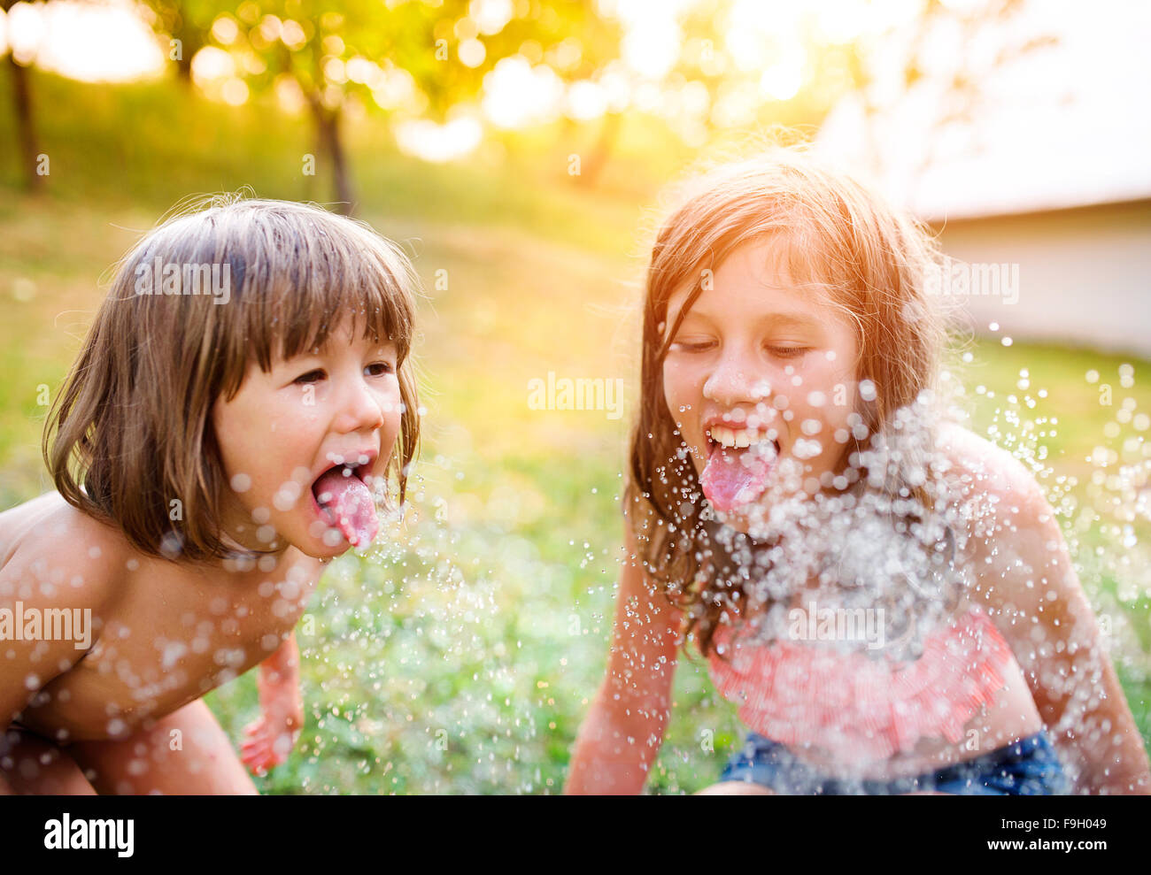 Beautiful kids having fun outside in the garden Stock Photo - Alamy
