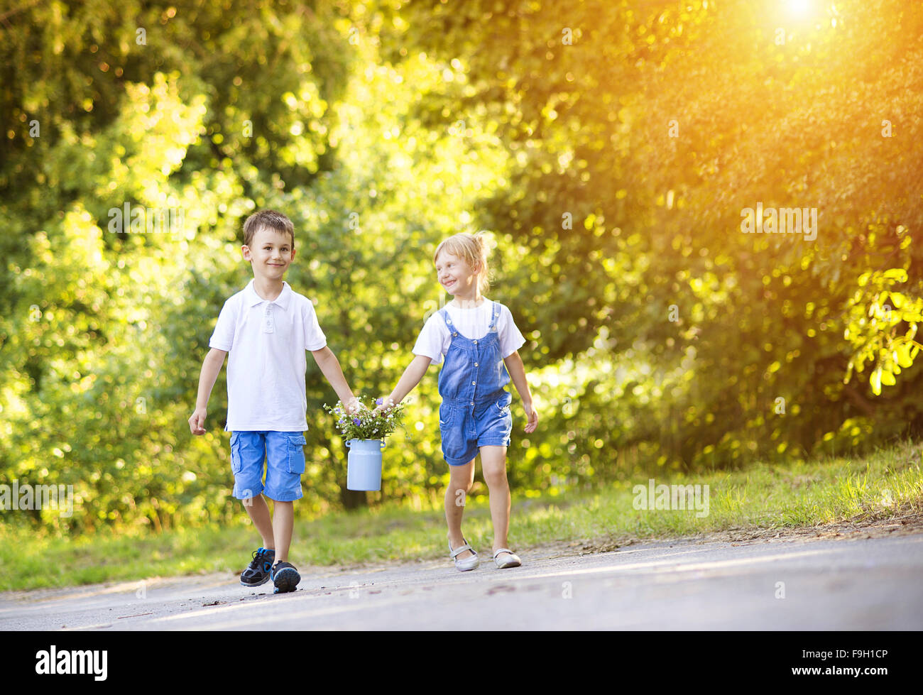 Cute little boy and girl taking a walk outside in nature on a sunny ...