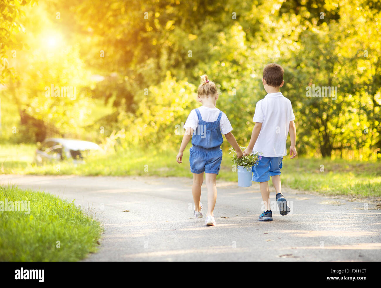Cute little boy and girl taking a walk outside in nature on a sunny ...
