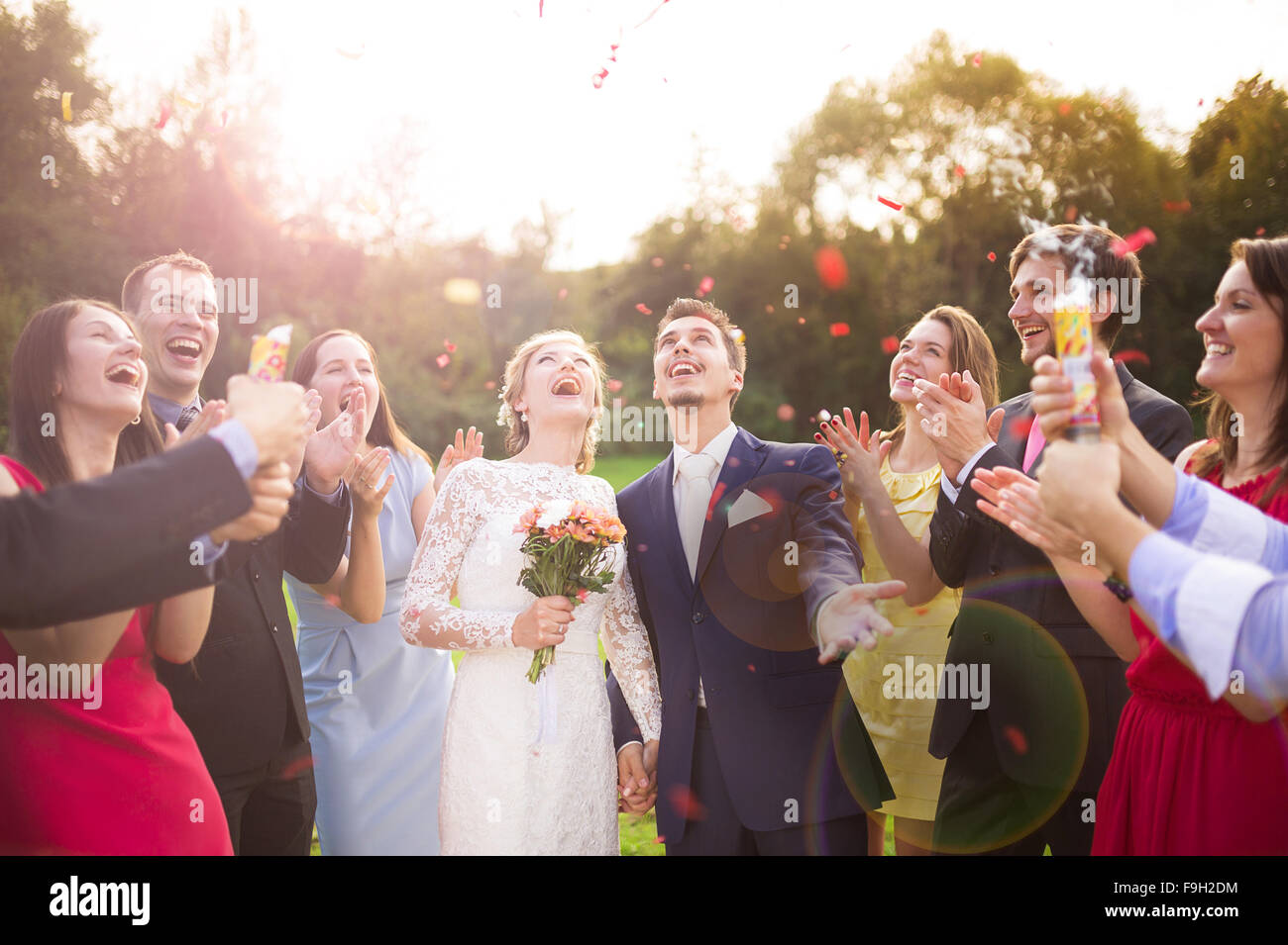 Full length portrait of newlywed couple and their friends at the ...