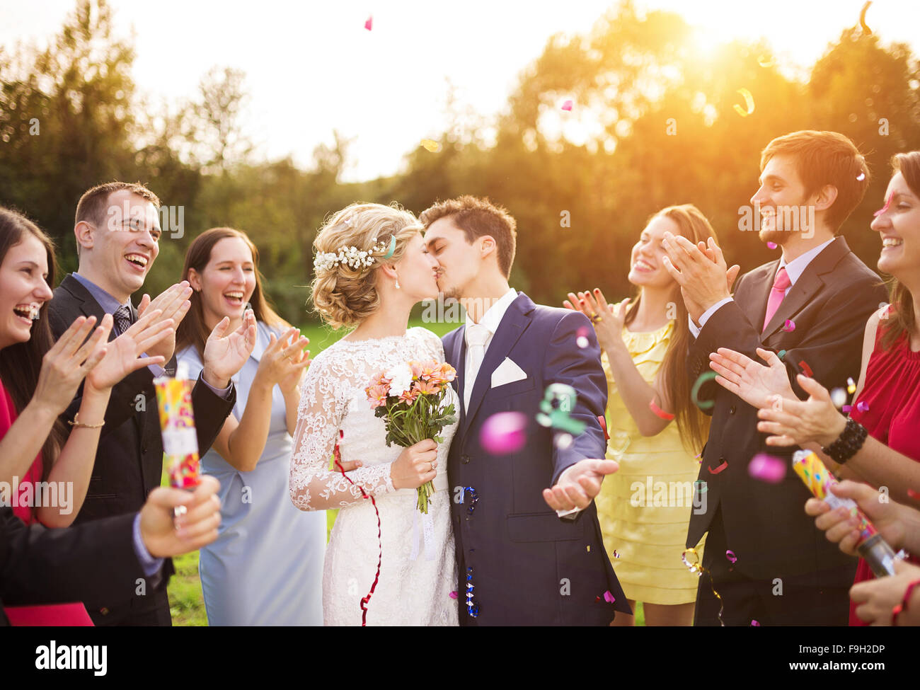 Full length portrait of newlywed couple and their friends at the ...