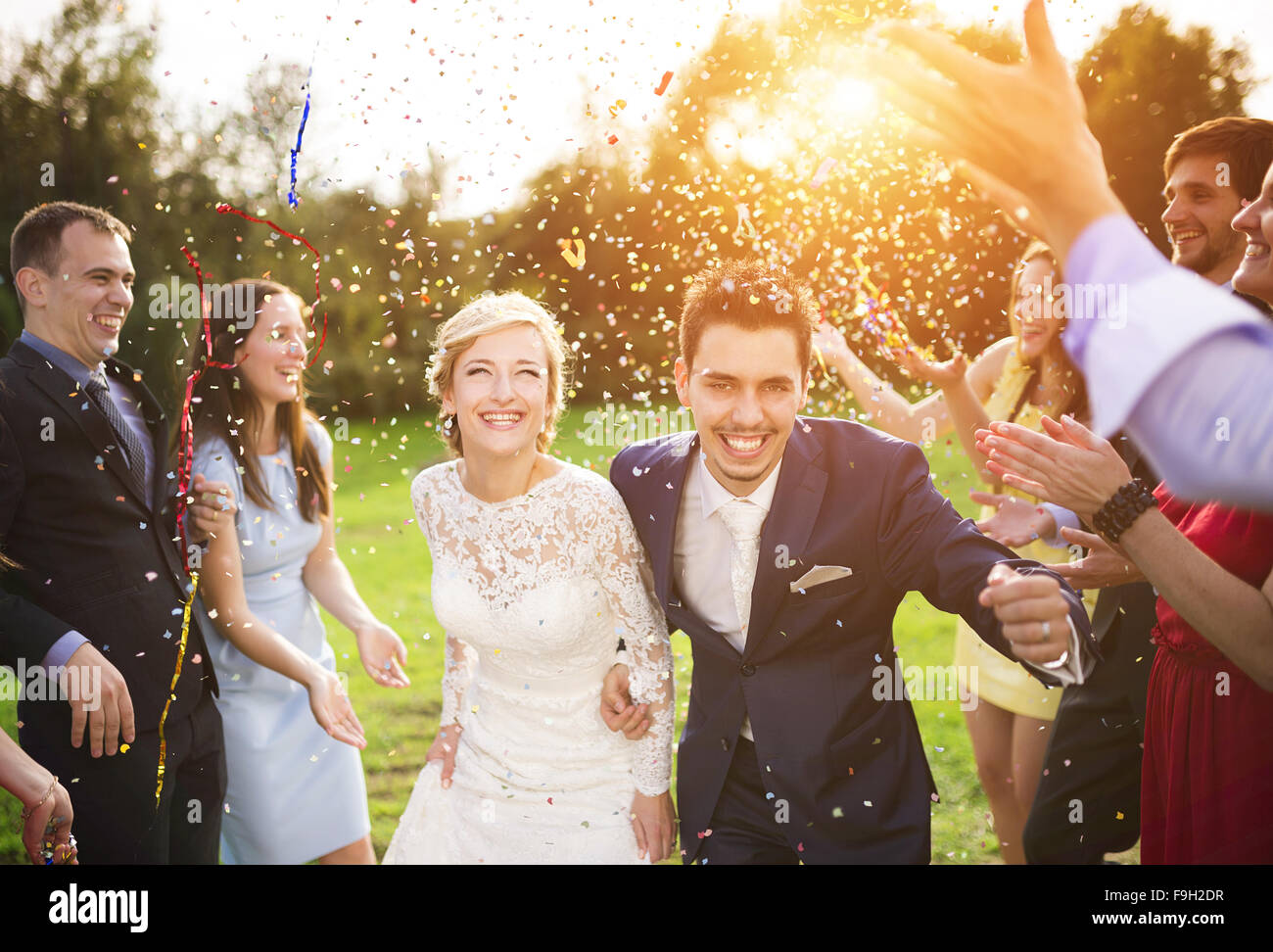 Full length portrait of newlywed couple and their friends at the ...