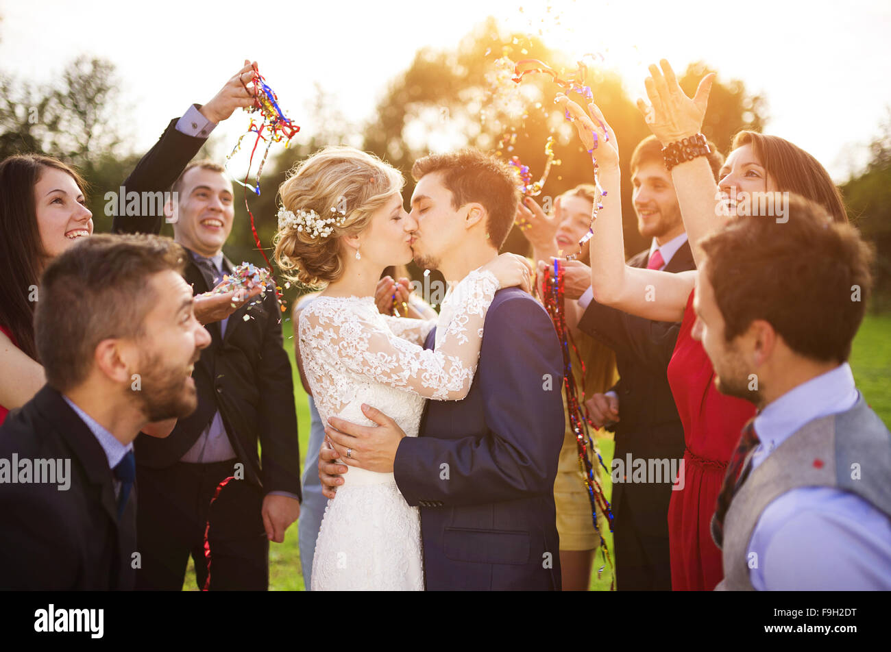 Full length portrait of newlywed couple and their friends at the ...