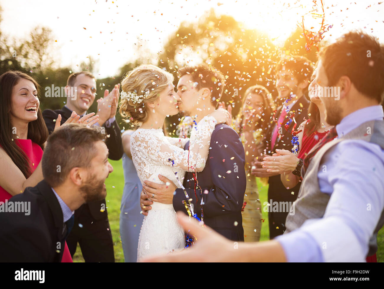 Full length portrait of newlywed couple and their friends at the ...