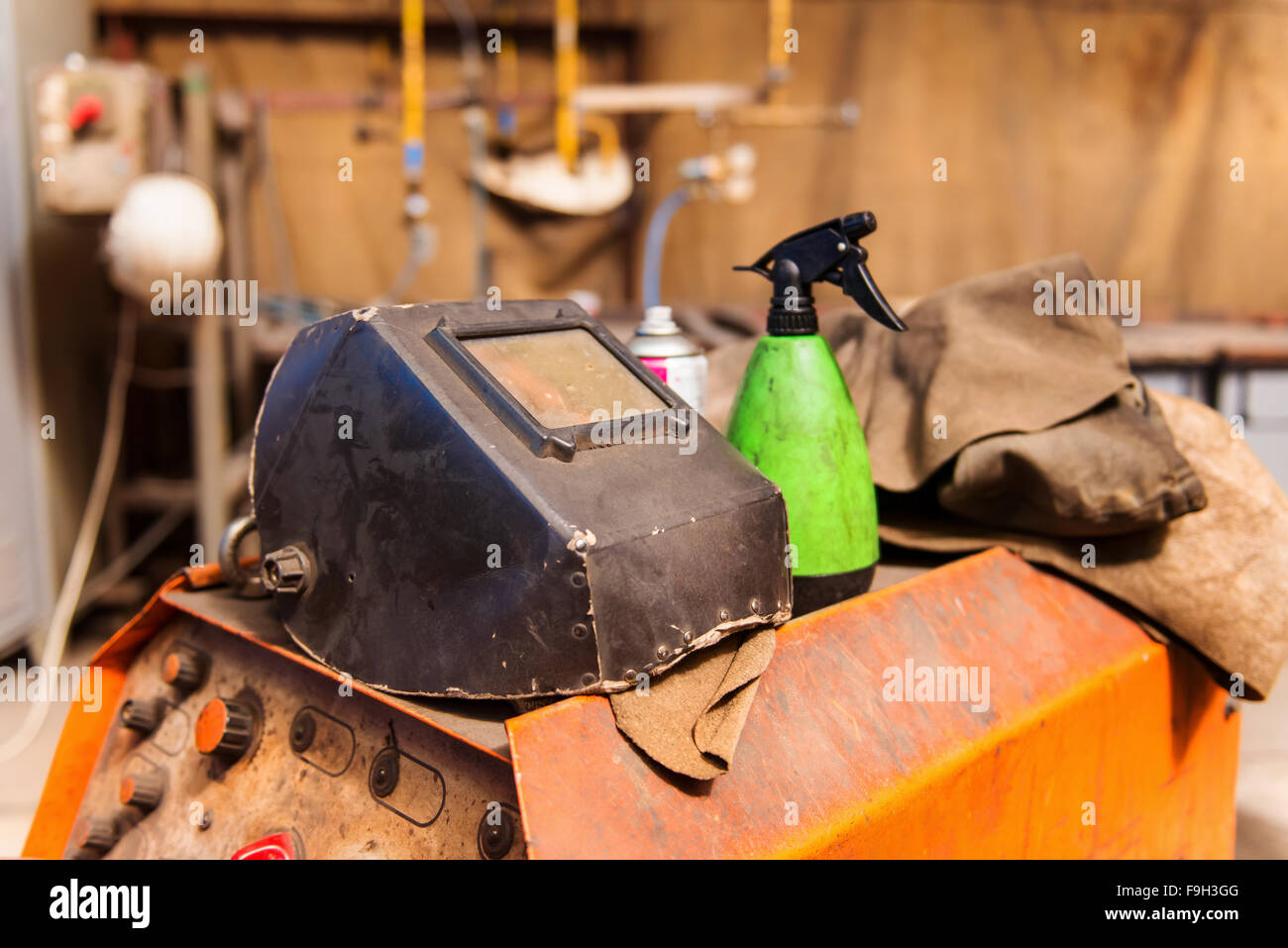 Welding shield laid on a welding machine and other equipment in small ...