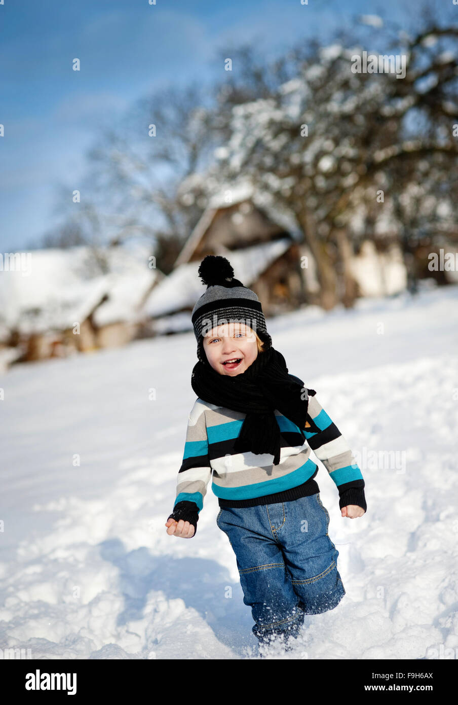 Cute little boy playing outside in the snow in winter Stock Photo - Alamy