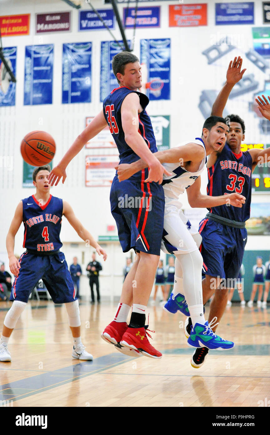 After driving on the hoop, a closely guarded high school forward dishes ...