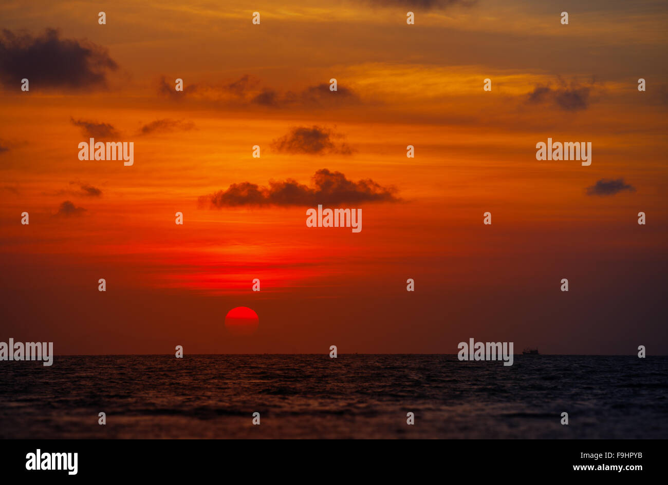 Red ball of the sun, burning through the haze of the late afternoon sky ...