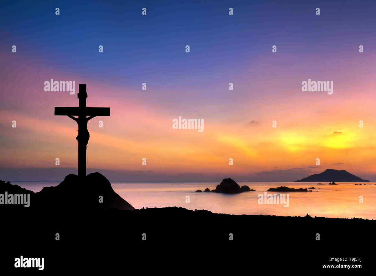 christian cross on sunset background Stock Photo - Alamy