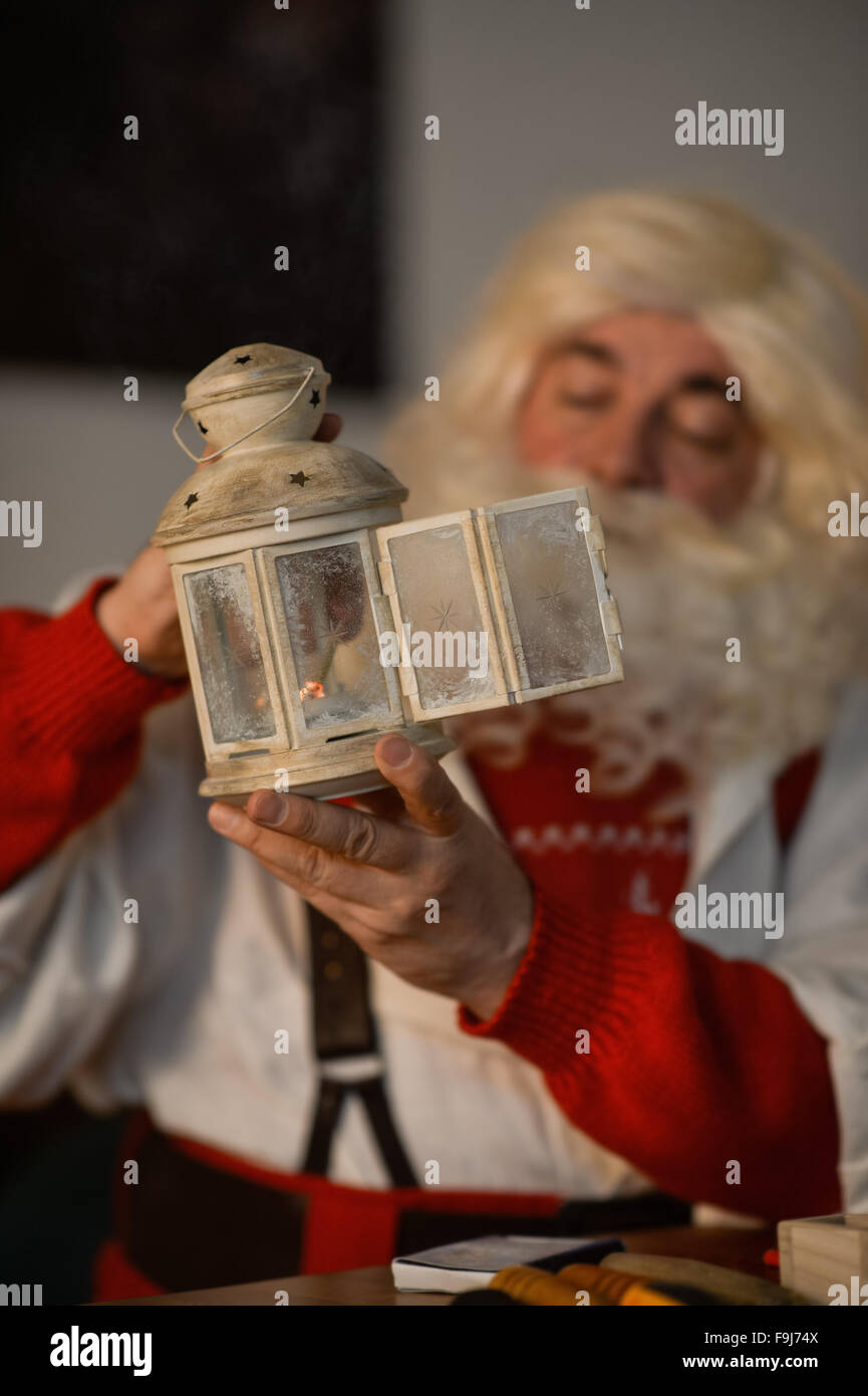 Santa Claus at Home holding lantern Stock Photo - Alamy