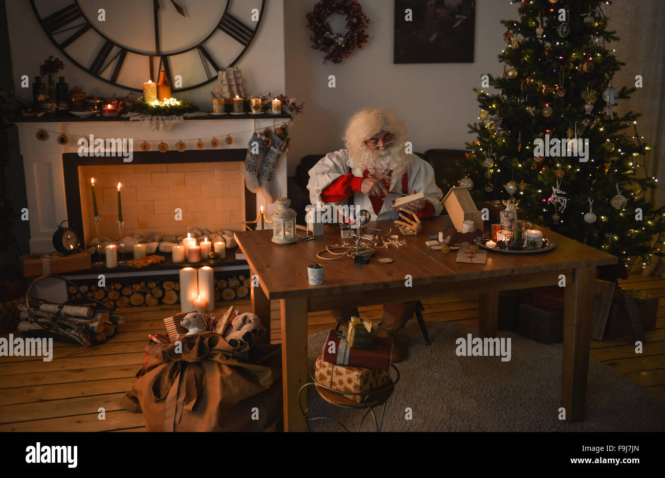 Santa Claus at Home carving something from wooden plank Stock Photo - Alamy