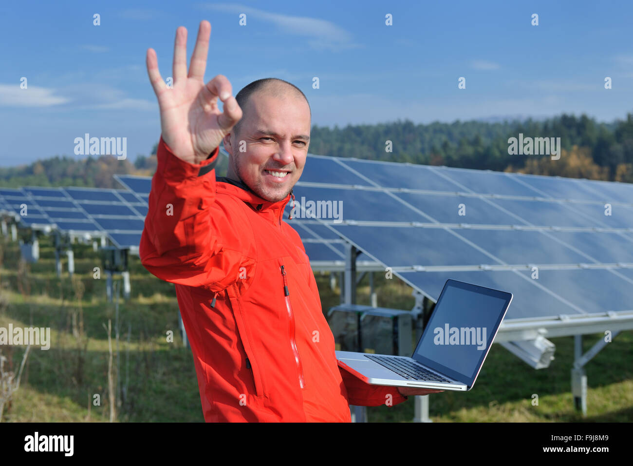 business man engineer using laptop at solar panels plant eco energy ...