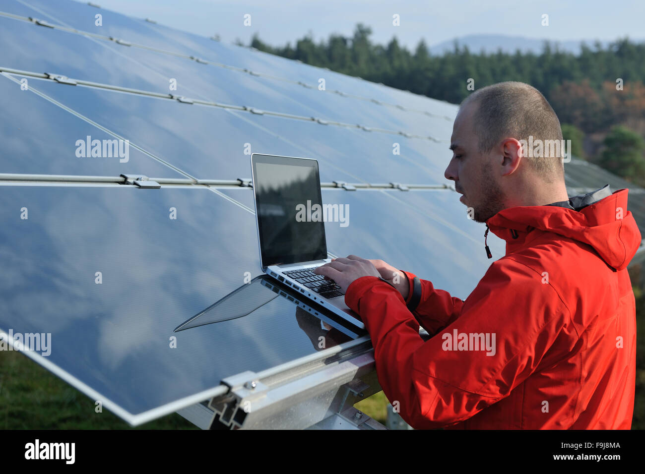 business man engineer using laptop at solar panels plant eco energy ...