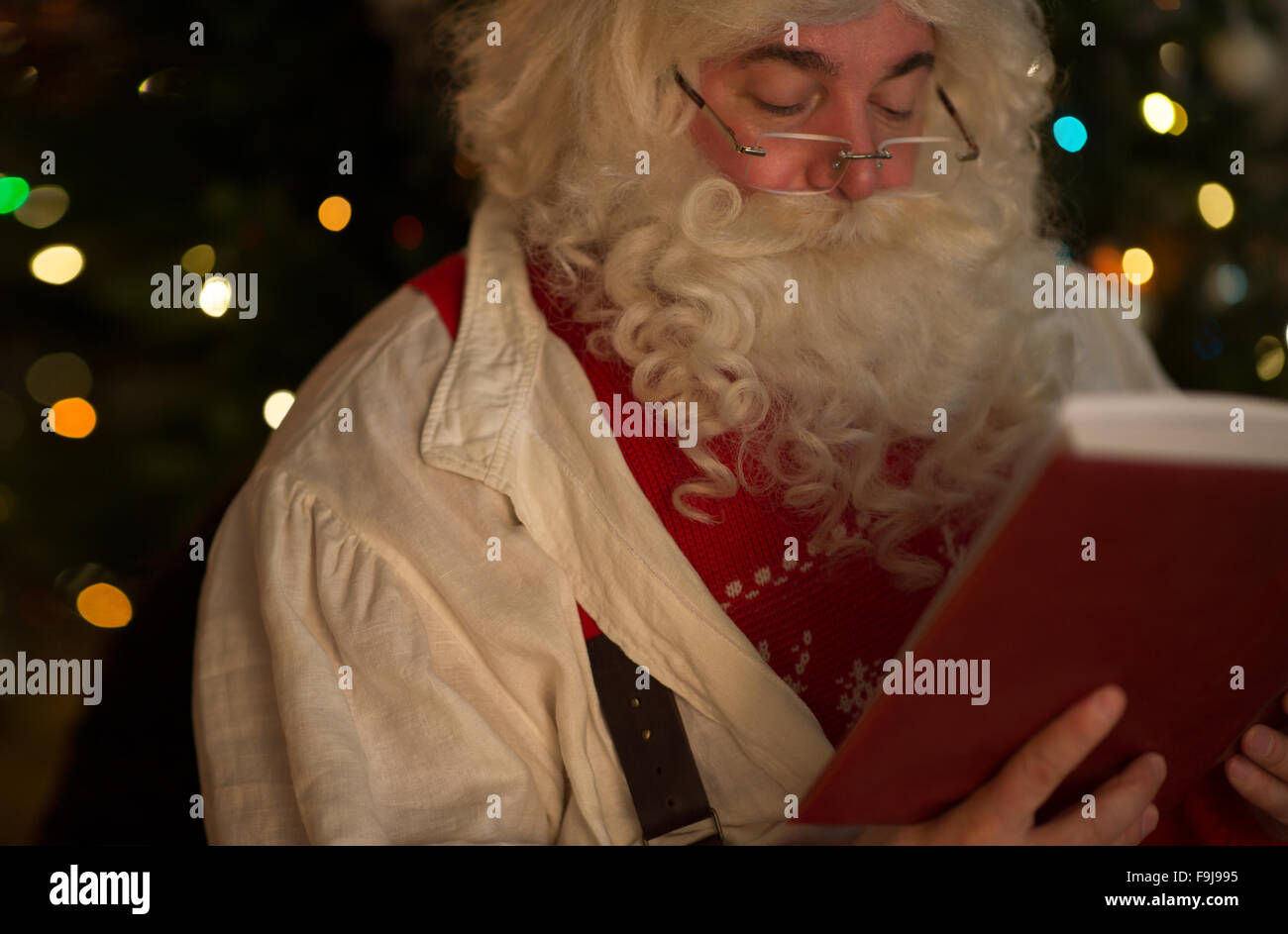 Santa Claus at Home reading book Stock Photo - Alamy