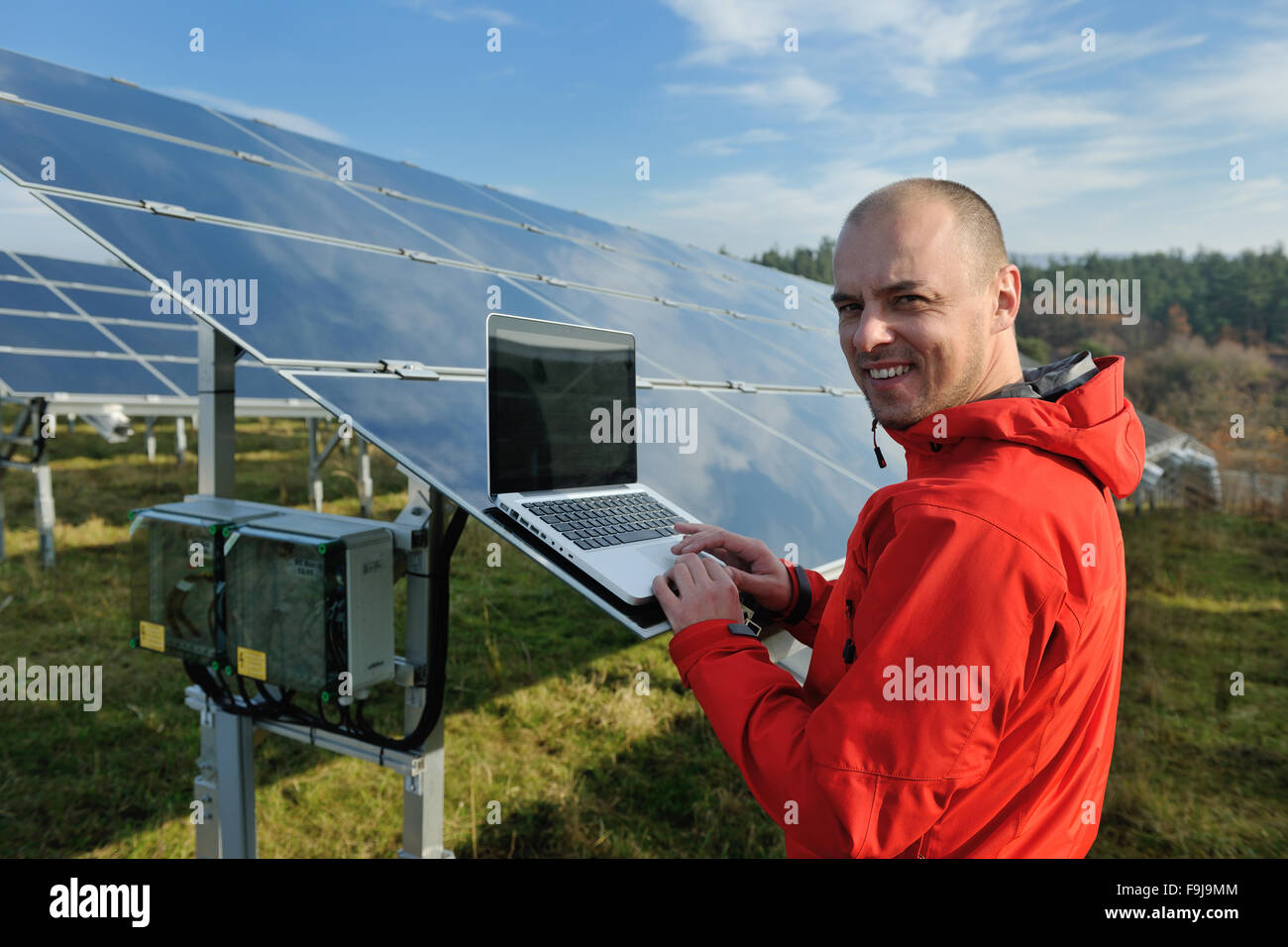 business man engineer using laptop at solar panels plant eco energy ...